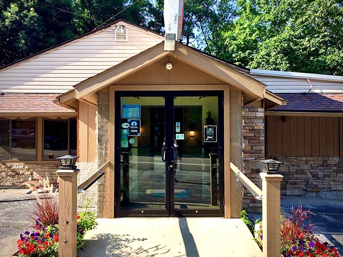 The entrance says "Welcome" without saying a word—seasonal flowers and stone accents hint at the warmth waiting inside.