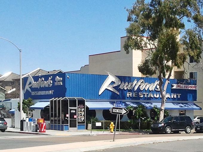 The exterior's bright blue trim and bold signage have been beckoning hungry San Diegans for decades, promising "EAT 24 HRS" in no uncertain terms.