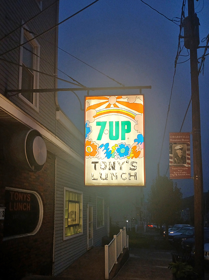 As dusk falls, the illuminated sign transforms from burger joint advertisement to cultural landmark. A Pennsylvania night light guiding hungry travelers home.