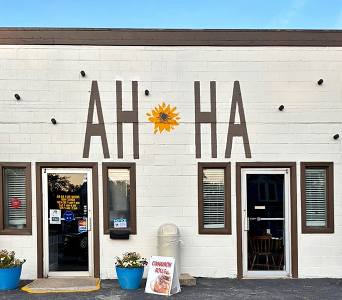 The bright white exterior with bold "AH-HA" lettering and blue planters is like a beacon of hope for hungry travelers.