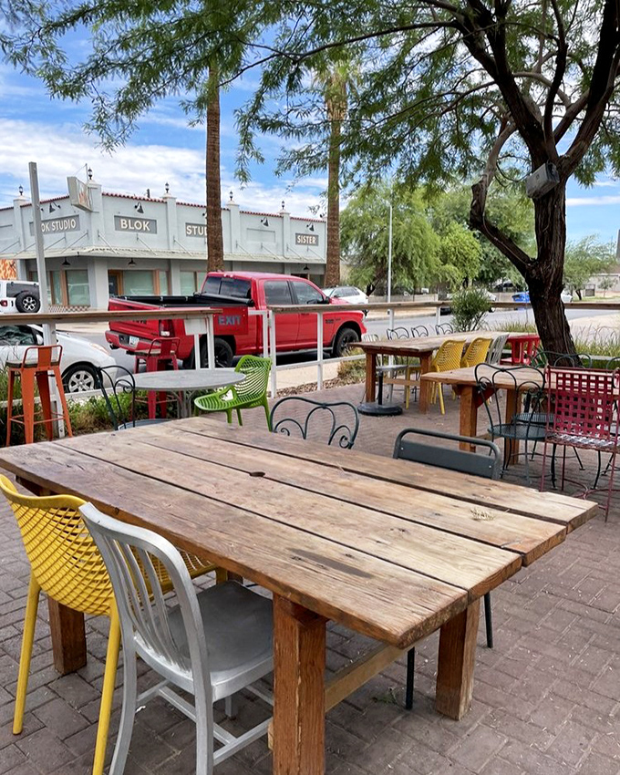 Mismatched chairs in cheerful colors surround rustic wooden tables&mdash;the outdoor dining equivalent of a warm hug from an eccentric aunt.