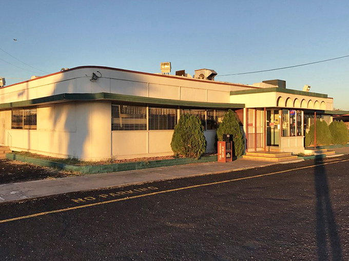 Sunset casts a golden glow on Mel's, transforming an everyday diner into something almost magical as day transitions to evening.