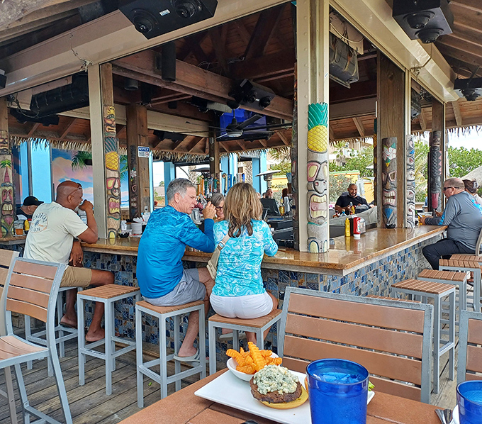 The outdoor bar – where "just one more" becomes the afternoon motto. Wooden stools, ocean breezes, and drinks that taste like liquid sunshine.