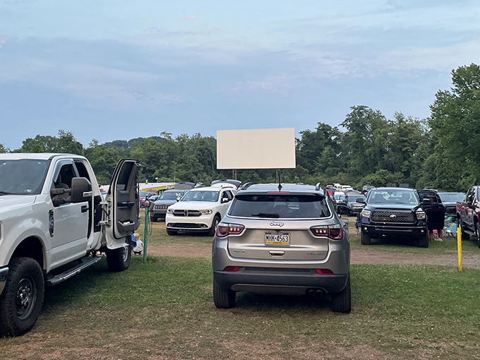 SUVs and sedans form an automotive amphitheater, each vehicle a private box seat under Pennsylvania's open skies.