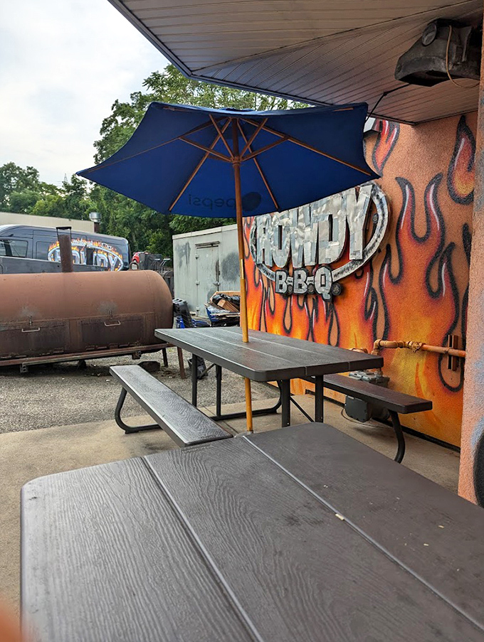 The outdoor dining area with its blue umbrella offers a front-row seat to barbecue paradise. Sometimes the best dining rooms have no walls and plenty of fresh air.
