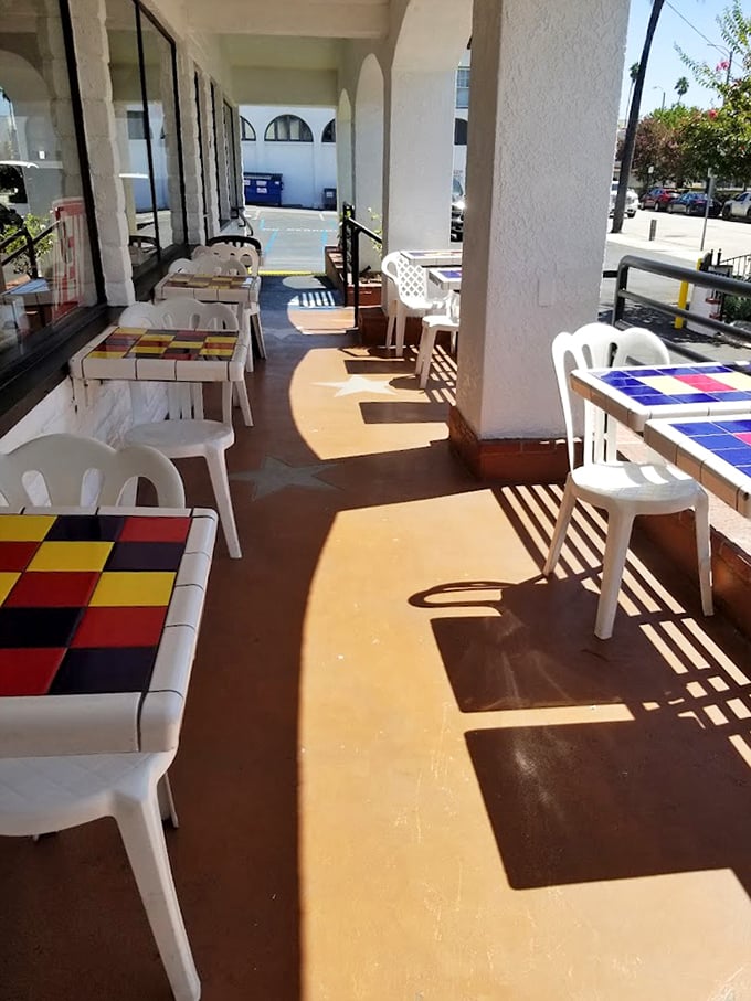 The outdoor dining area offers colorful tiled tables where California sunshine enhances every bite.