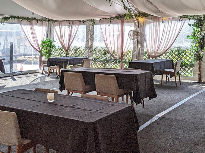 Outdoor dining with just the right amount of romance &ndash; those flowing curtains are practically auditioning for a lifestyle magazine.