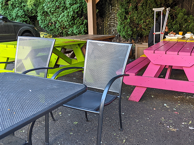 Colorful picnic tables create a playful outdoor dining space. Portland's famous rain doesn't stop true waffle enthusiasts from their mission.