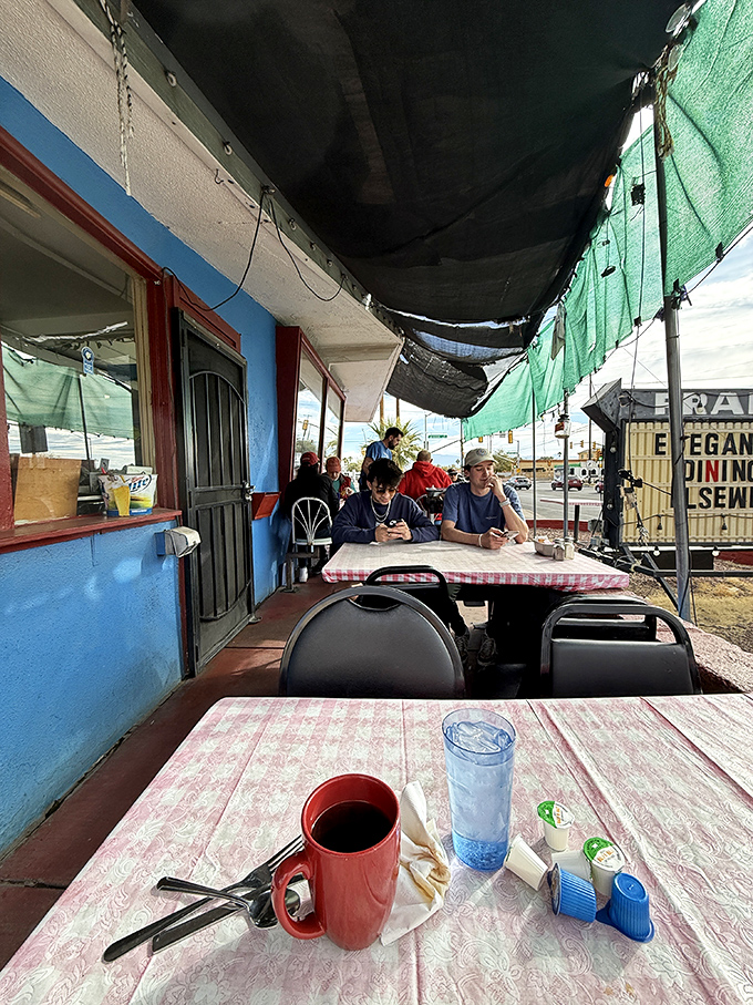 The outdoor seating area offers fresh air with your fresh coffee &ndash; red mugs and checkered tablecloths create that classic diner vibe.