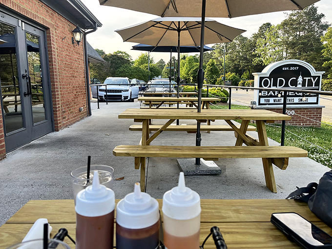 Sauce bottles standing at attention on outdoor tables&mdash;the condiment equivalent of "locked and loaded" for your barbecue battle.
