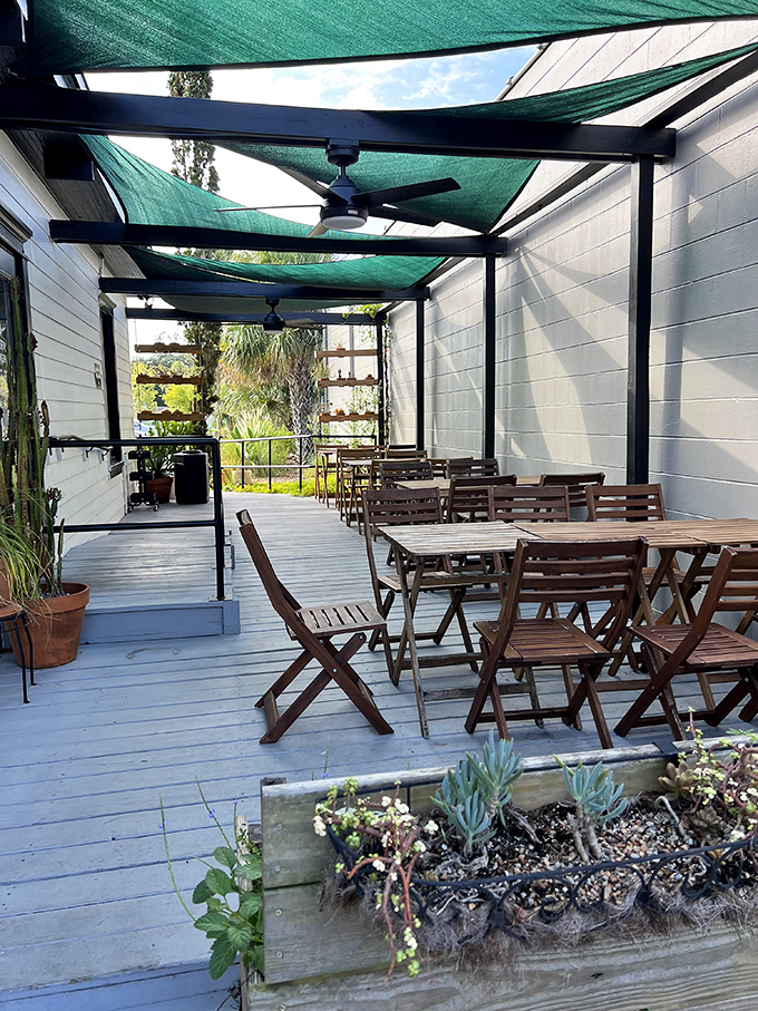 The covered patio provides shaded sanctuary for outdoor dining where Florida weather meets French pastry perfection.