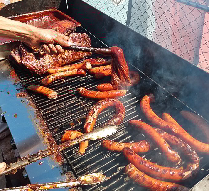 Meat in its natural habitat: sizzling on the grill, transforming from raw potential into smoky perfection through fire and patience.