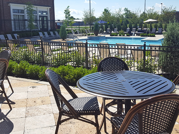 Outdoor seating by the pool, because sometimes dinner needs a side of chlorine-scented summer breeze.