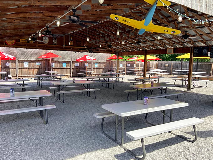 Covered outdoor dining with string lights and picnic tables &ndash; because sometimes BBQ tastes even better with a gentle breeze and the sound of laughter.