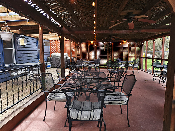The screened porch dining area offers the perfect compromise between "I want to be outside" and "but not with the bugs, please."