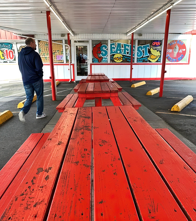 Red picnic tables stand ready for outdoor dining, where Oregon's occasional sunshine makes every burger taste even better.