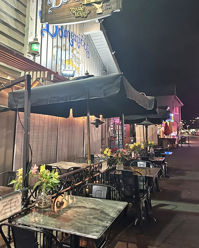 Evening transforms the outdoor seating into a romantic escape &ndash; string lights twinkling above as the harbor's nighttime symphony plays on.