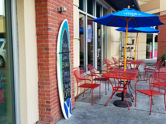The outdoor seating area, complete with surfboard menu, offers fresh air and people-watching opportunities between bites of burger perfection.