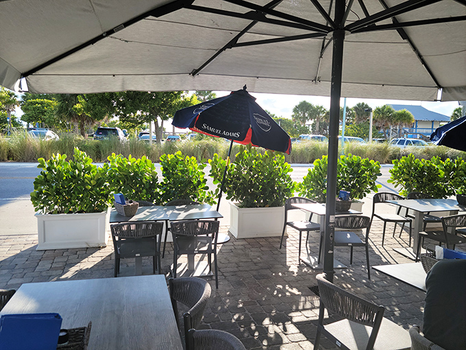 The outdoor patio&mdash;where umbrellas provide shade, sea breezes provide ambiance, and nobody's checking their watch because island time is the only time that matters.