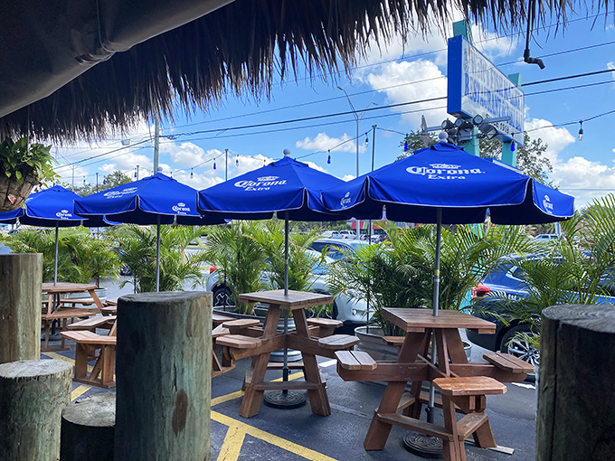 Outdoor seating that captures the essence of Florida dining&mdash;blue umbrellas, wooden tables, and the promise of fresh catches.