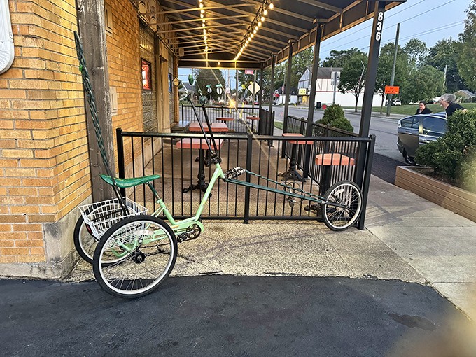 The humble patio entrance, complete with neighborhood bicycle, invites you to park your pretensions at the door and come as you are.