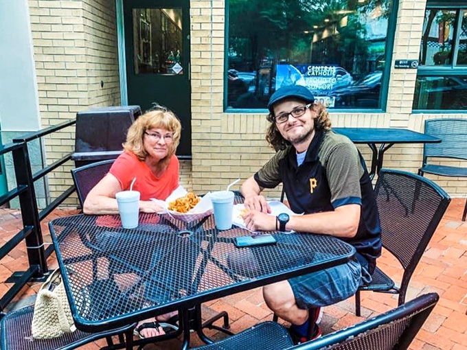 Sidewalk seating extends the maritime experience outdoors where city meets sea in perfect Pittsburgh harmony.