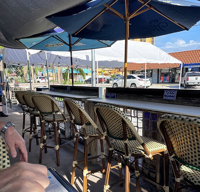 Outdoor seating where ocean breezes complement every bite. These woven chairs have cradled countless happy diners between beach visits.