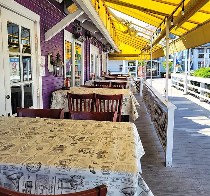 The purple exterior and yellow awning create a cheerful backdrop for outdoor dining&mdash;newspaper-print tablecloths hint at the messy deliciousness to come.
