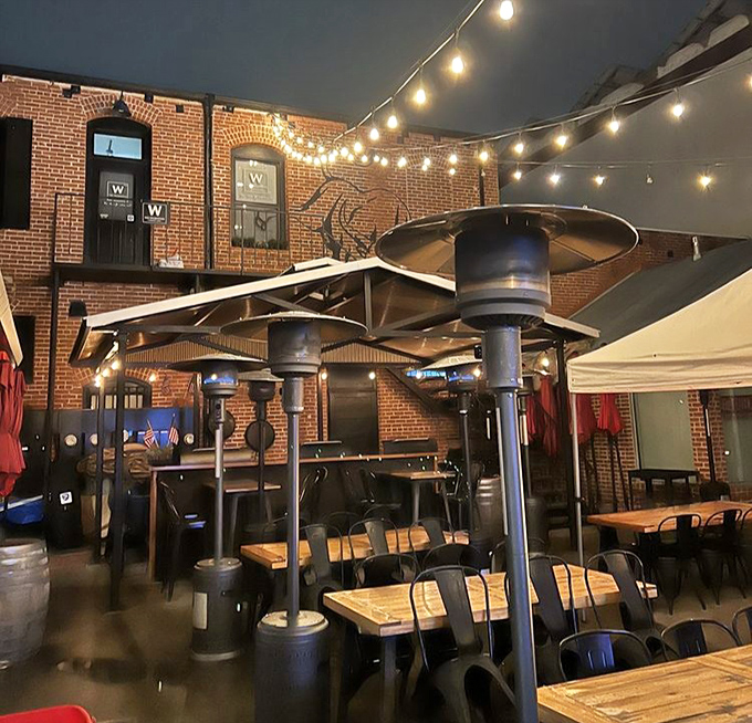 Evening light transforms the patio into barbecue heaven, where heat lamps ensure comfort while flavors warm your soul.