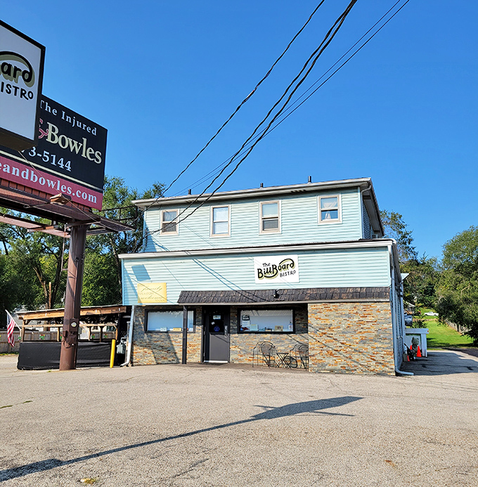 Daytime reveals the bistro's charming blue exterior, standing proudly on its corner like the neighborhood's favorite uncle.