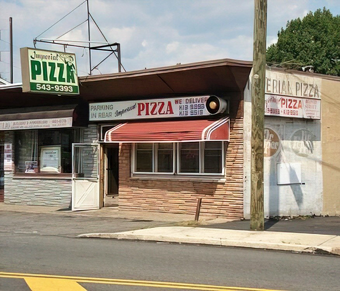 Imperial Pizza in daylight reveals its humble charm. This unassuming storefront houses pizza greatness that fancy establishments can only dream about.