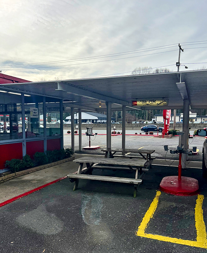 Picnic tables offer a chance to enjoy your feast al fresco, though most regulars prefer the classic experience of dining right in their cars.