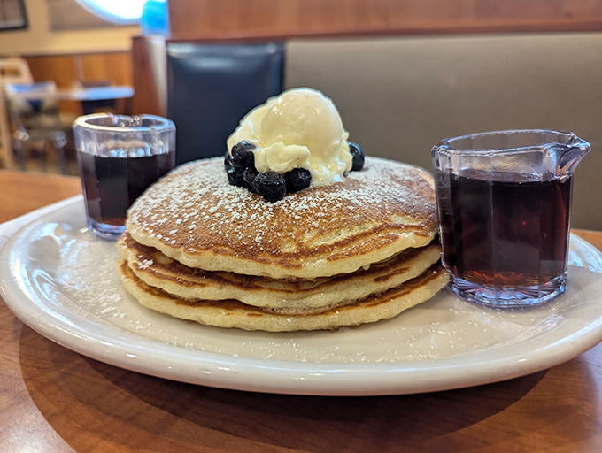 Pancakes stacked higher than your weekend ambitions, crowned with a scoop of vanilla ice cream and fresh berries &ndash; breakfast or dessert? Yes.