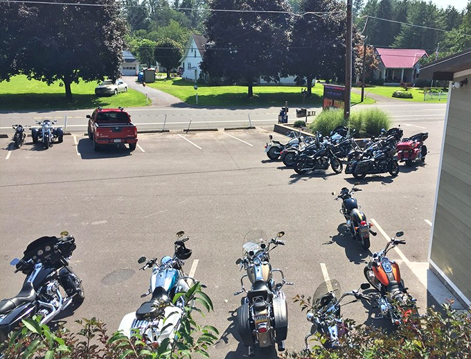 The parking lot on a busy day—where motorcycles gather like iron horses at a watering hole, drawn by the siren call of BBQ.