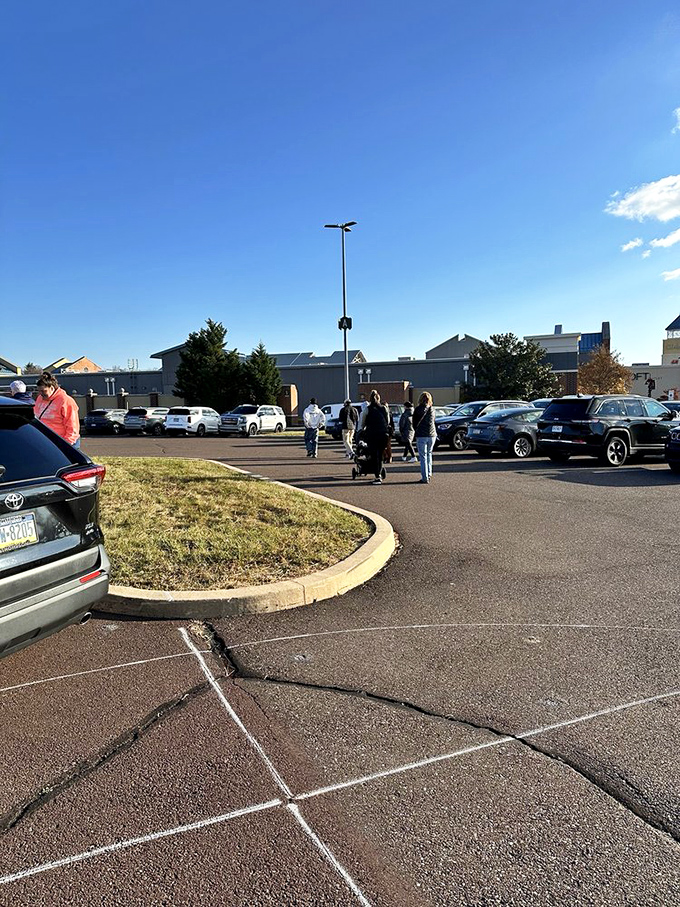 Even the parking lot tells a story of retail pilgrimage, as shoppers make their determined way toward buildings that house fashion treasures at fraction prices. 