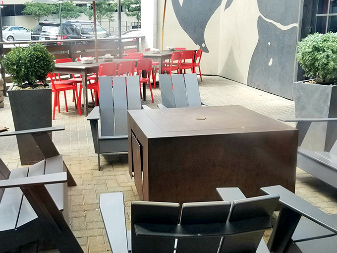 The patio's modern furniture and clean lines provide a contemporary contrast to the restaurant's rustic interior—best enjoyed with a cold drink.