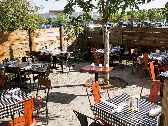 Outdoor patio dining extends the experience under California skies &ndash; al fresco barbecue bliss with checkered table charm.