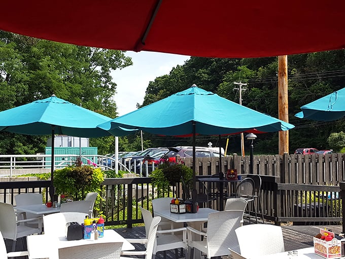 The outdoor patio offers a breath of fresh air under those turquoise umbrellas. Nature and nurture combine for the perfect alfresco dining experience.