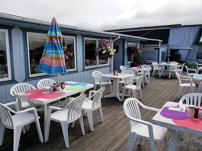 Colorful placemats brighten wooden deck tables where diners can feel the sea breeze enhance every bite of their freshly caught seafood feast.