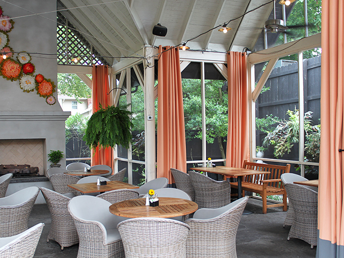 A sunlit porch dining area where wicker chairs and coral accents create the perfect backdrop for morning conversations.