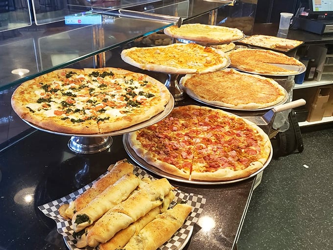 A display case of pizzas that makes choosing just one feel like Sophie's Choice: The Carbohydrate Edition.