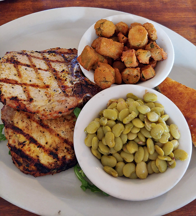 A pork chop that would make your grandma proud, nestled beside fried okra and lima beans. This plate screams "Sunday dinner" any day of the week.