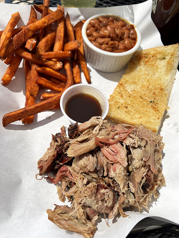 The pulled pork sandwich that launched a thousand road trips. Worth driving across state lines for—just ask the license plates in the parking lot.