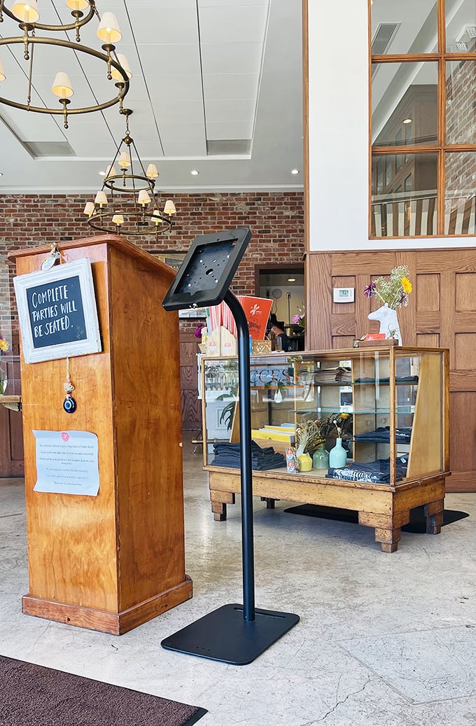 The entrance speaks volumes: "Complete parties will be seated." A gentle reminder that good things come to those who gather their friends first.