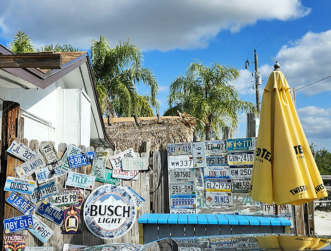 License plates from visitors past create a mosaic of memories on the wall&mdash;each representing someone who found their way to this riverside gem.