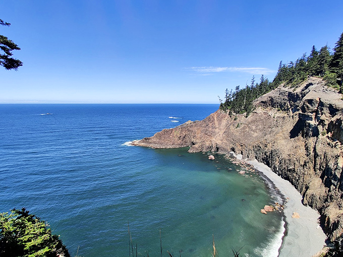 Hidden cove perfection: This secret beach tucked beneath towering cliffs feels like nature's version of finding money in an old coat pocket.