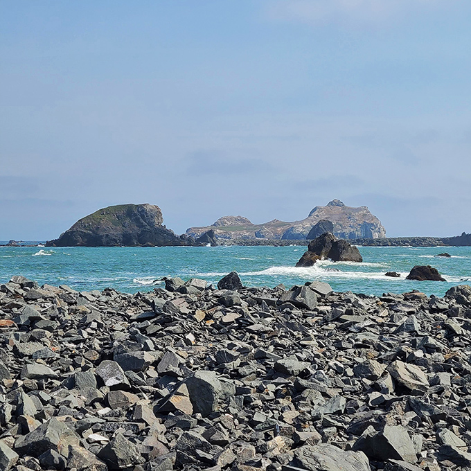 Rocky shores and offshore formations create a dramatic coastline that looks like it was designed specifically for moody landscape photography.