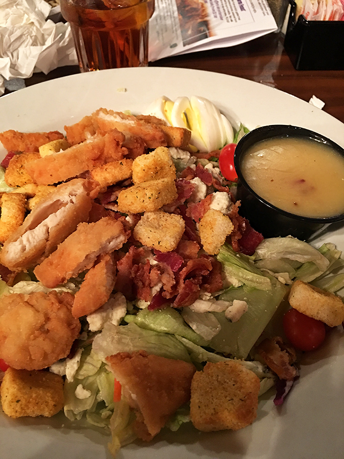 This isn't just a salad – it's a strategic arrangement of crisp lettuce, crunchy croutons, and protein that somehow makes vegetables seem exciting.