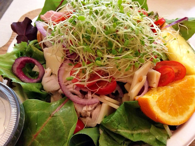 A salad that doesn't apologize for being healthy. Fresh greens, vibrant vegetables, and a crown of sprouts that adds both texture and bragging rights.