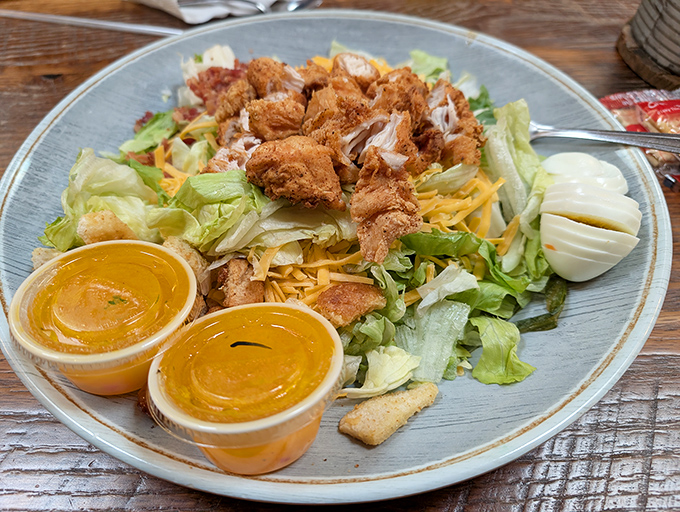 A salad that doesn't apologize for the fried chicken on top. Those golden nuggets and hard-boiled eggs make "eating healthy" a flexible concept.